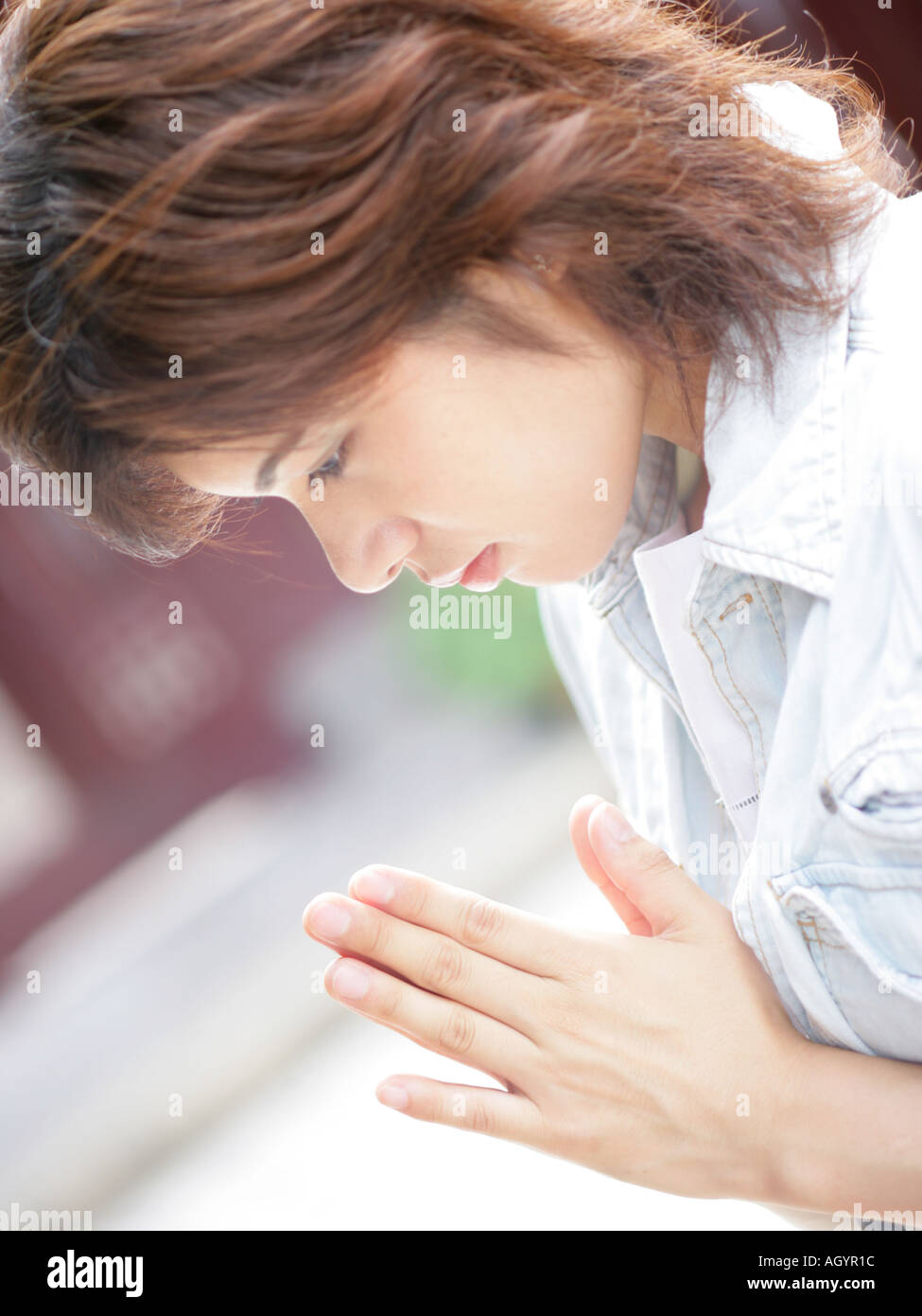 Side profile of a young woman praying Stock Photo - Alamy