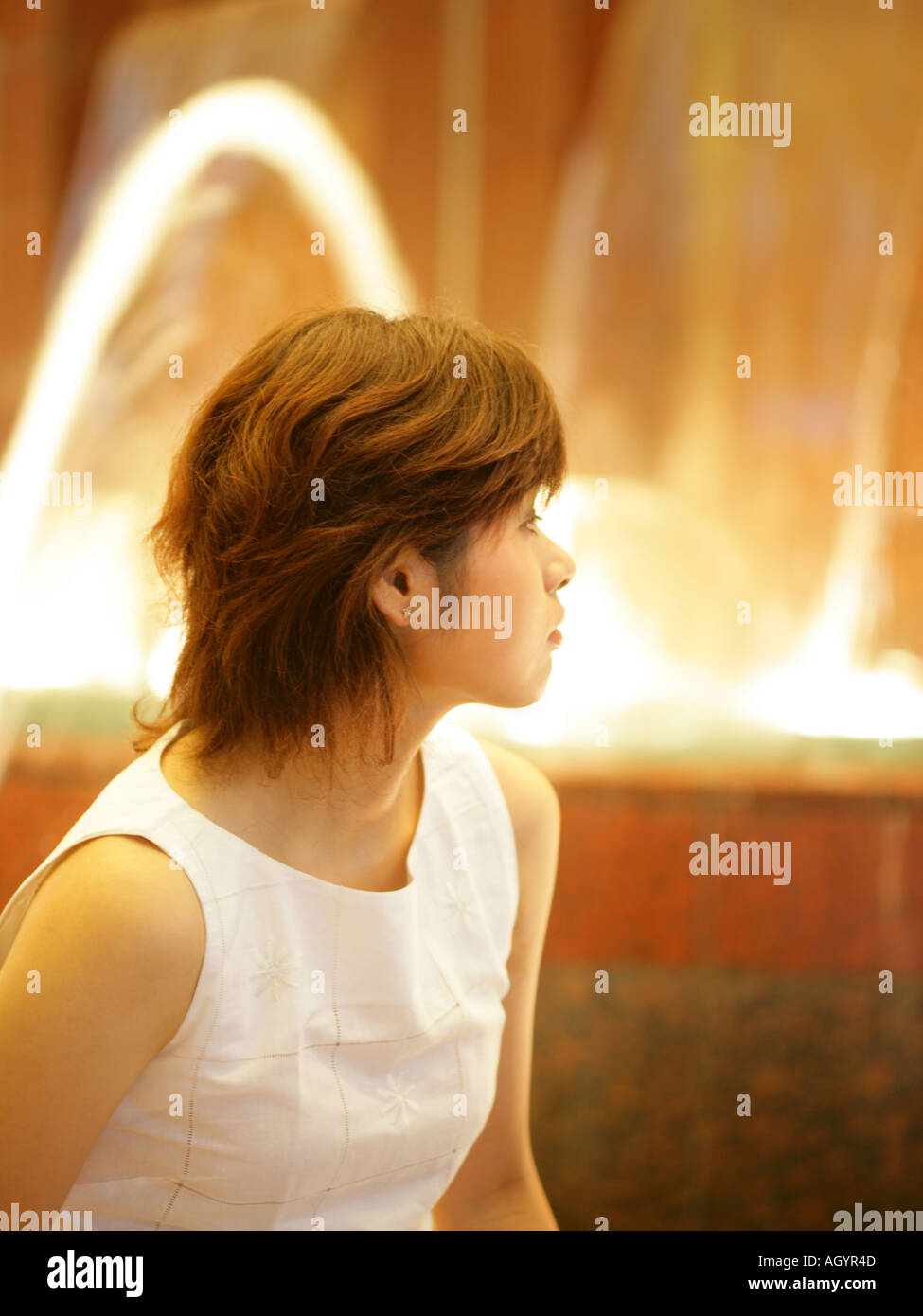 Side profile of a young woman sitting Stock Photo - Alamy