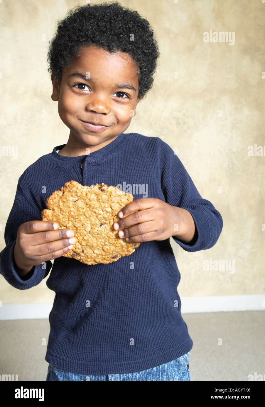 Young African American boy eating large cookie Stock Photo - Alamy