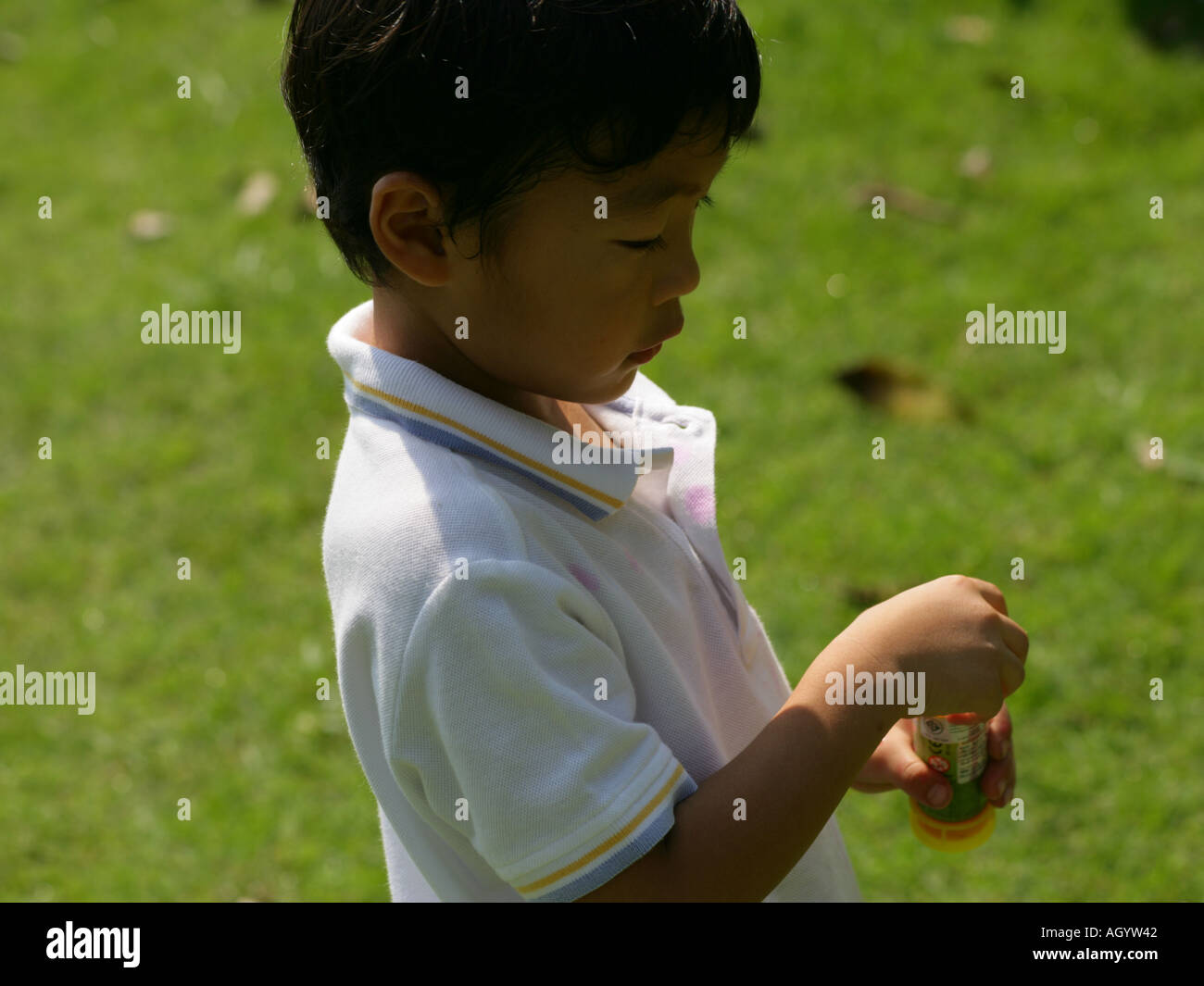 Side profile of a boy blowing bubbles with a bubble wand Stock Photo ...