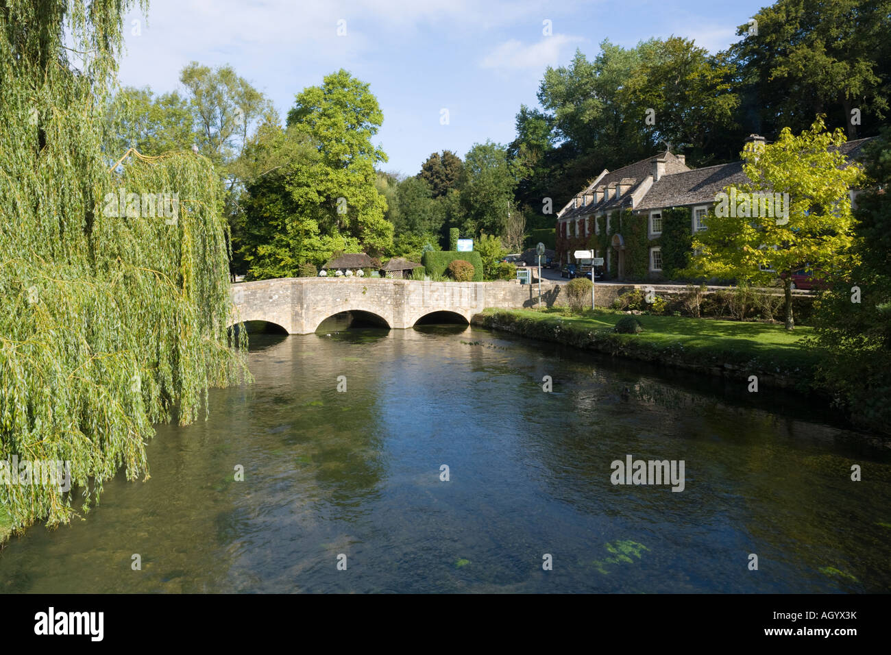 The River Coln flowing past the Swan Hotel in the Cotswold village of ...
