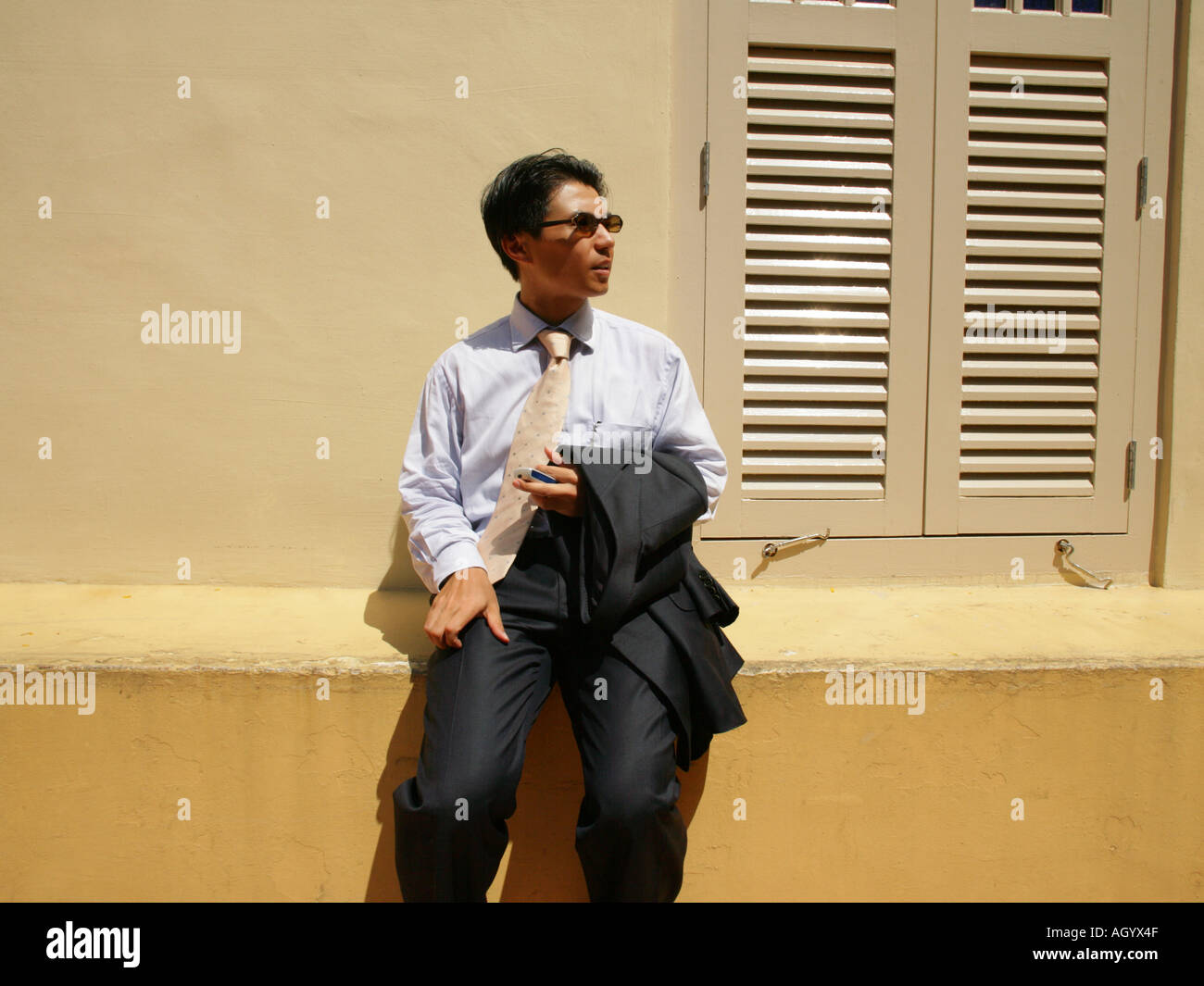 Man sitting on window ledge hi-res stock photography and images - Alamy
