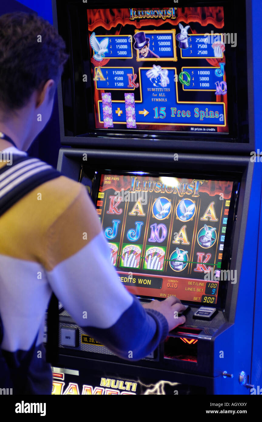 Young man playing slot machines hi-res stock photography and images - Alamy