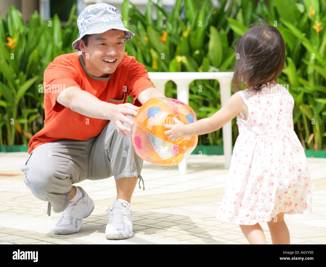 Father giving a ball to his daughter Stock Photo - Alamy