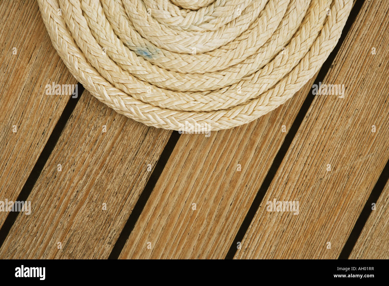Close-up of a curled up rope on the deck of a sailboat Stock Photo - Alamy