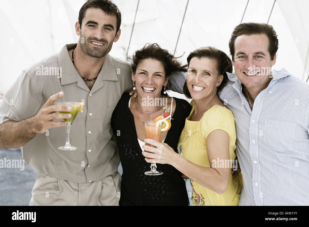 Two mid adult couples smiling together Stock Photo - Alamy