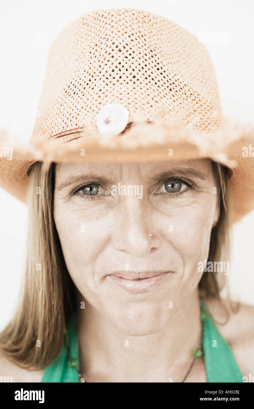 Close-up of a mid adult woman wearing a straw hat Stock Photo - Alamy