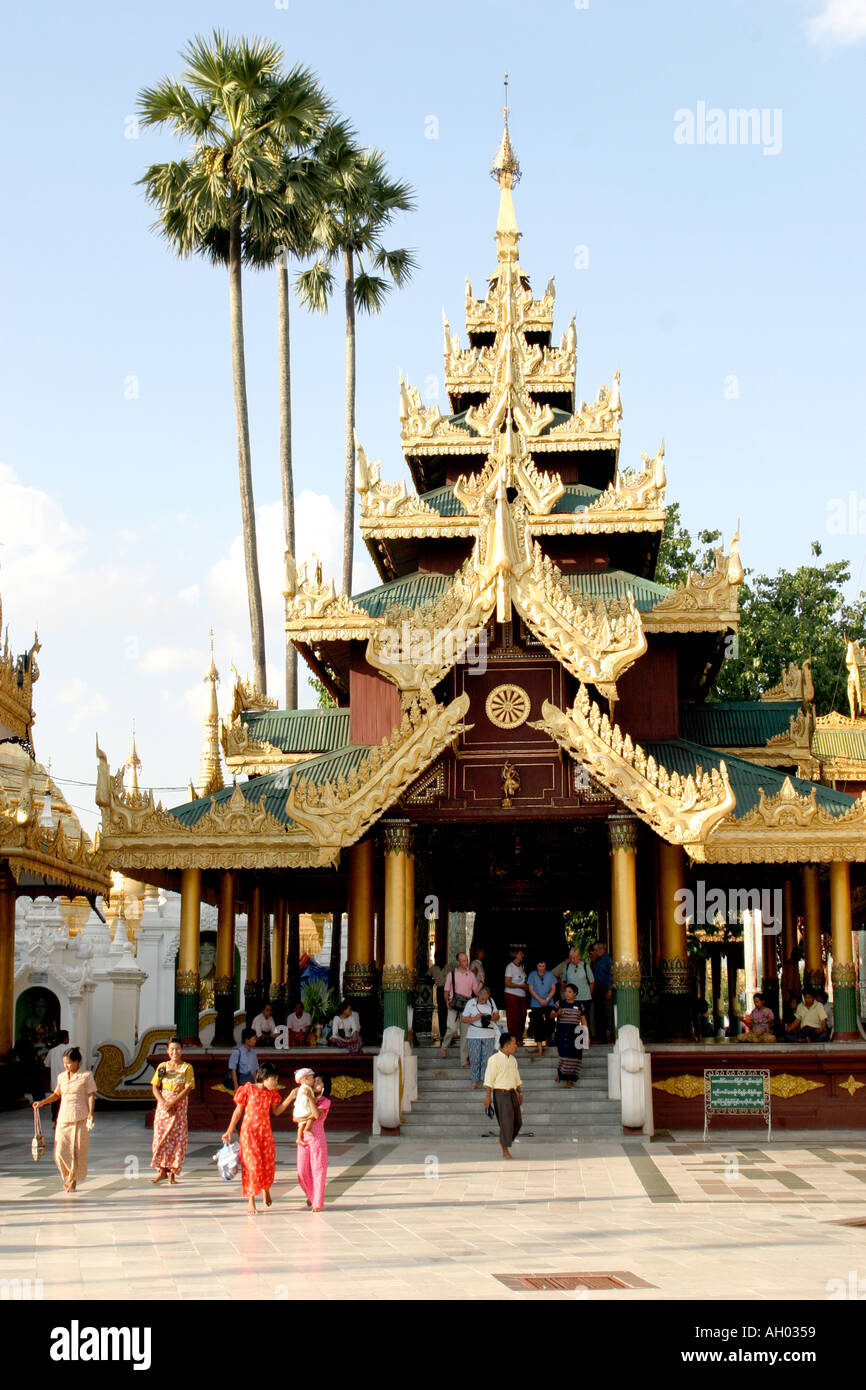 Giant Bell Pagoda at the Shwedagon Pagoda complex with people and palm ...