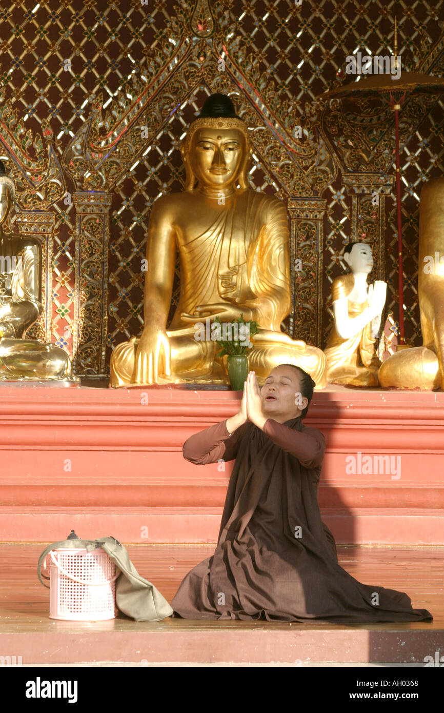 A devoted Buddhist woman shows her devotion in prayer at the Schwedagon ...