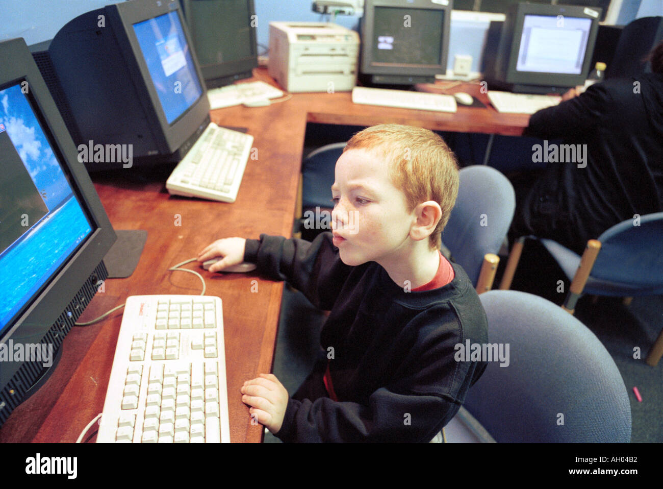 Boy frustrated by computer Stock Photo - Alamy