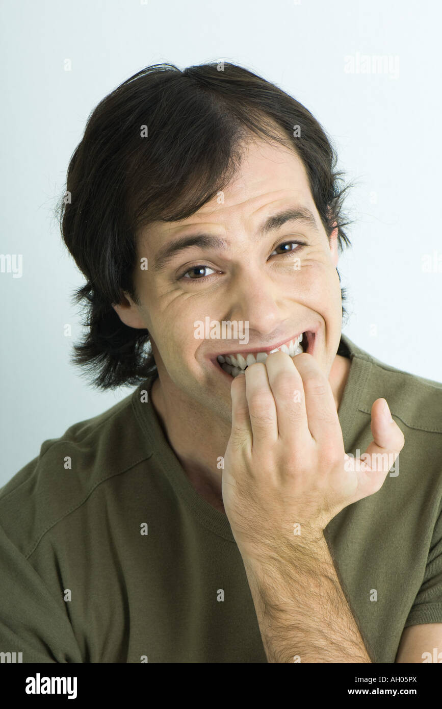 Man biting nails, portrait Stock Photo - Alamy