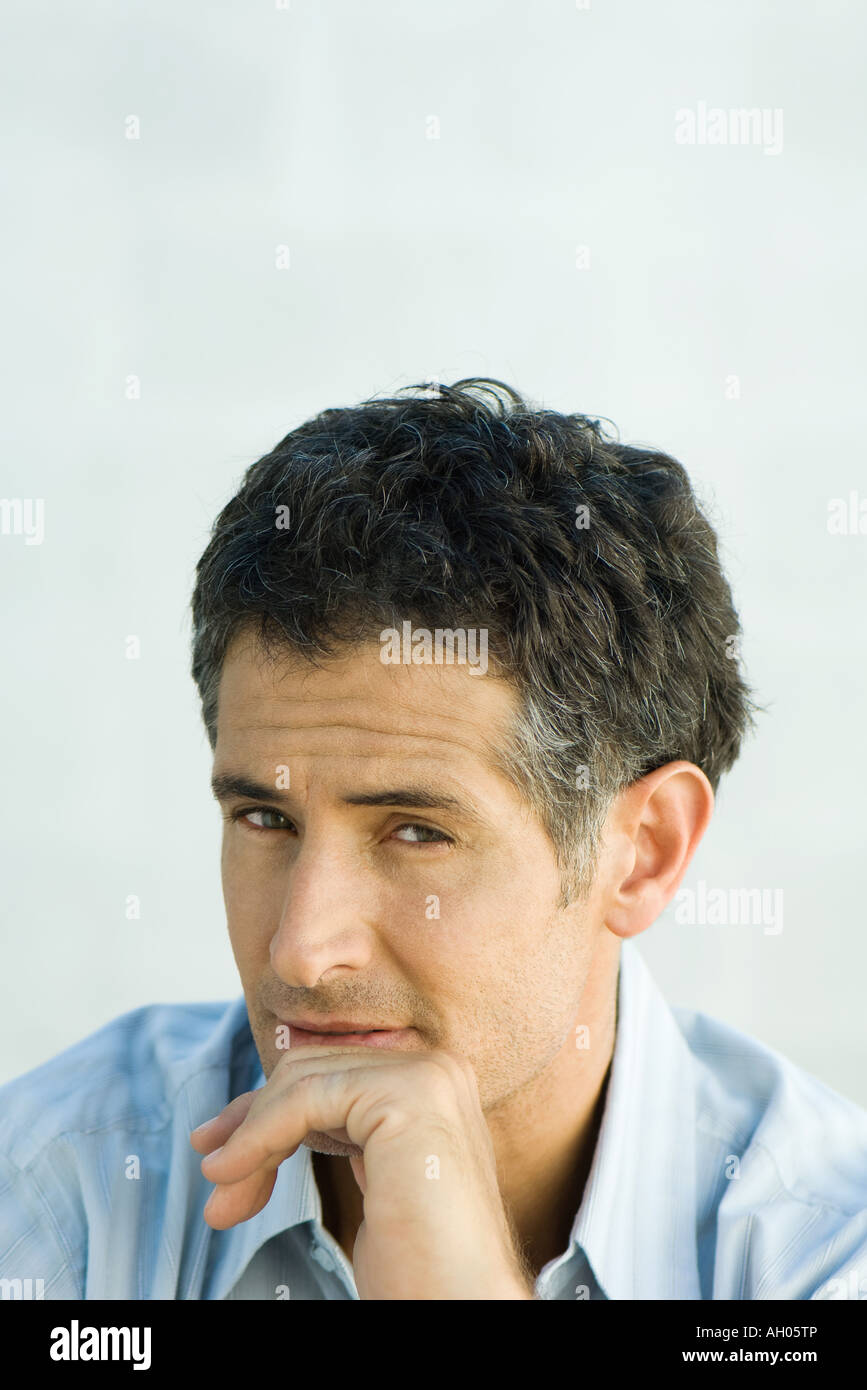 Man with hand on chin, portrait Stock Photo - Alamy