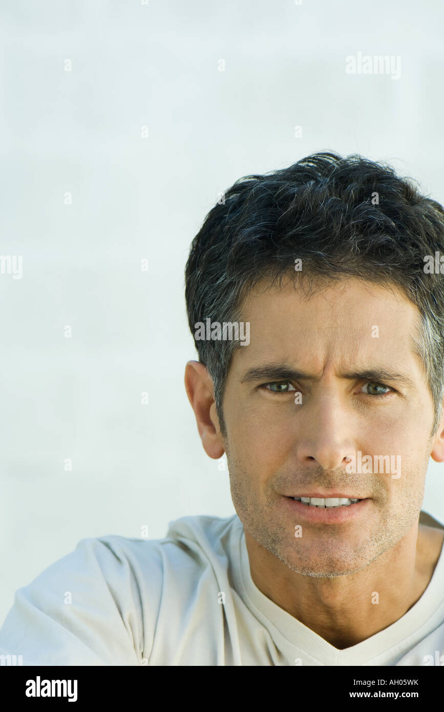Man clenching teeth and furrowing brow, portrait Stock Photo - Alamy