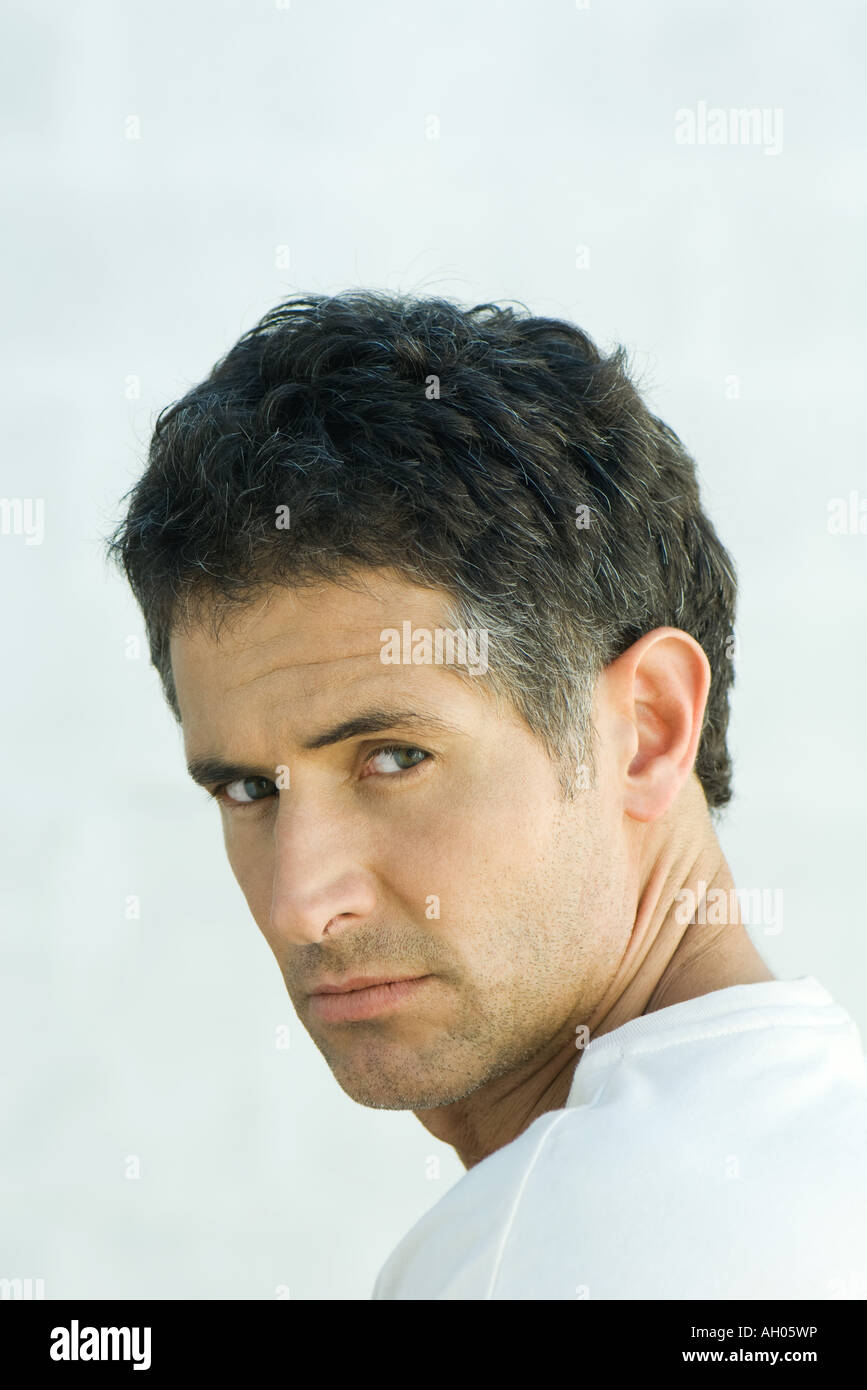 Man, looking over shoulder at camera, portrait Stock Photo - Alamy