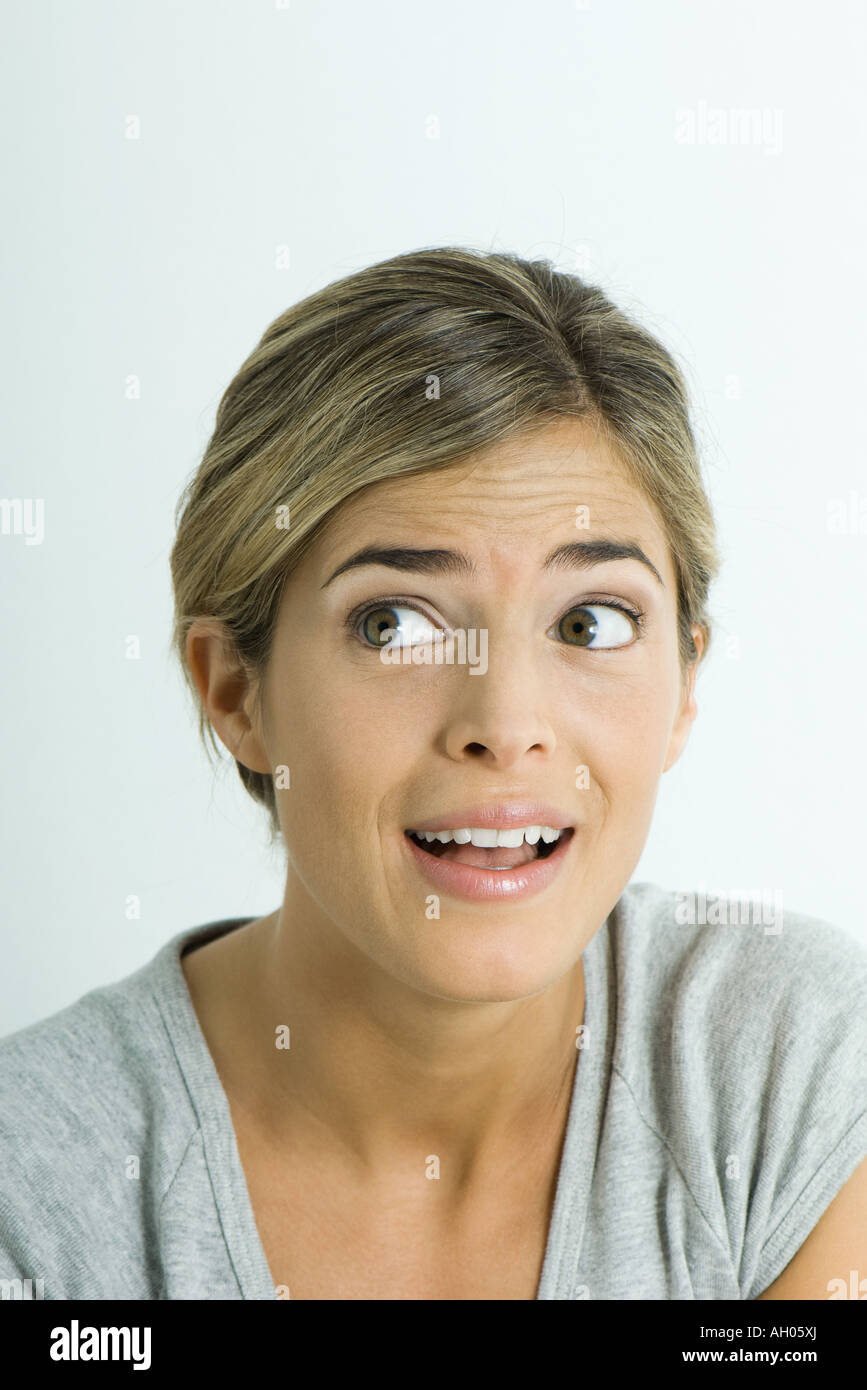 Young woman making surprised face, portrait Stock Photo - Alamy