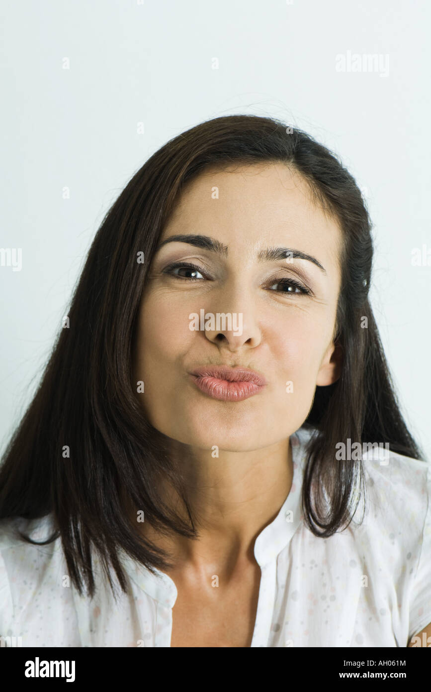 Woman puckering lips, looking at camera, portrait Stock Photo - Alamy