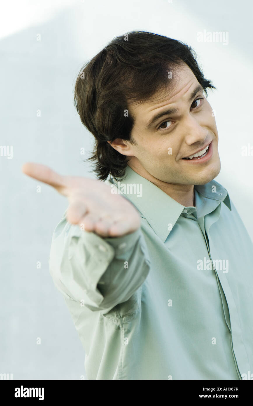 Man holding out hand to camera, portrait Stock Photo - Alamy