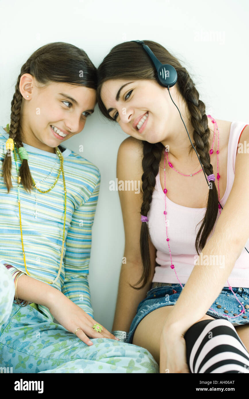 Two young female friends touching heads together Stock Photo - Alamy