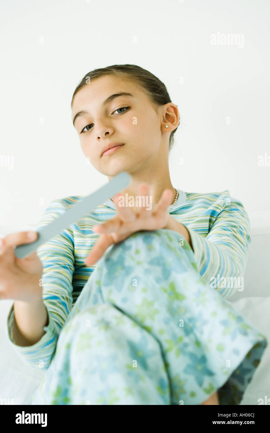 Girl filing nails Stock Photo - Alamy