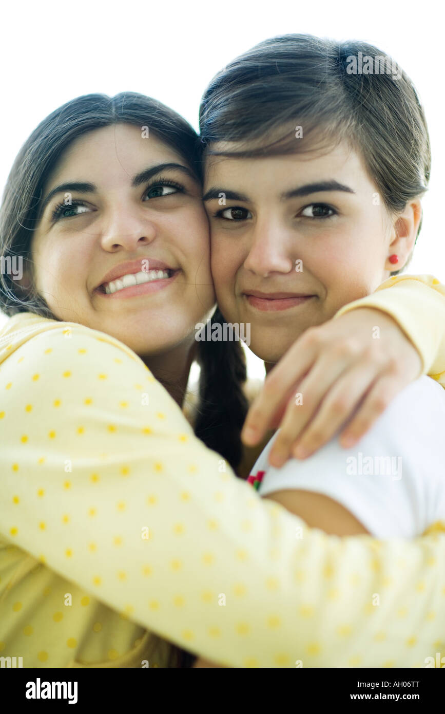 Young female friends hugging, portrait Stock Photo - Alamy