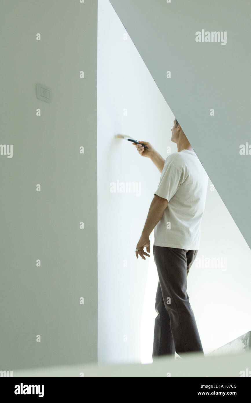 Man painting wall with paintbrush Stock Photo - Alamy