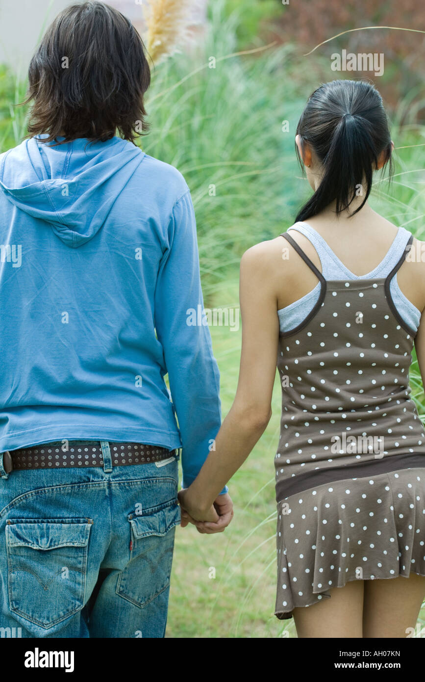 Young couple holding hands, rear view Stock Photo - Alamy