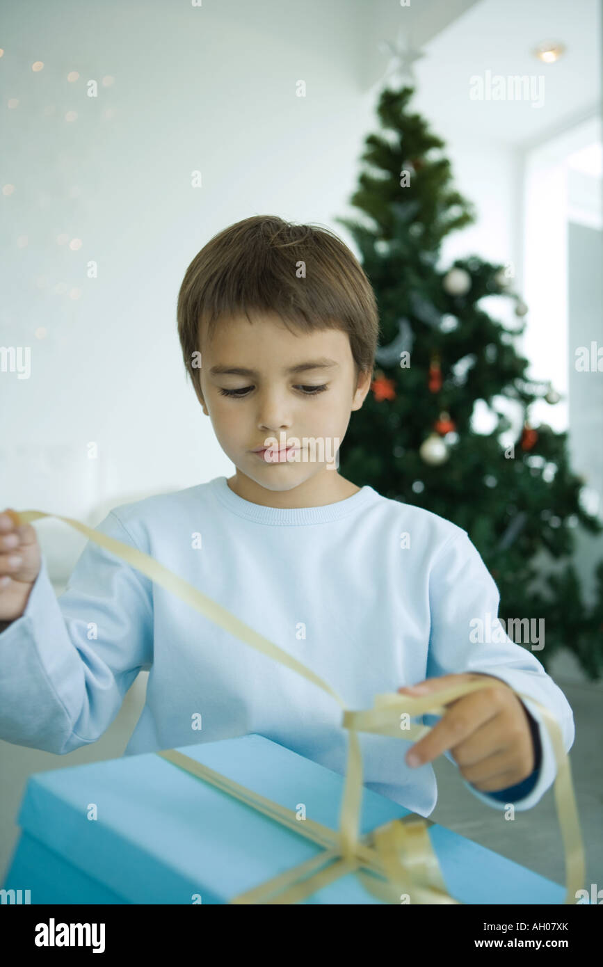 Boy opening Christmas presents Stock Photo - Alamy