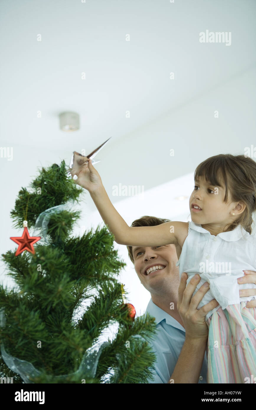 Man lifting christmas tree hi-res stock photography and images - Alamy