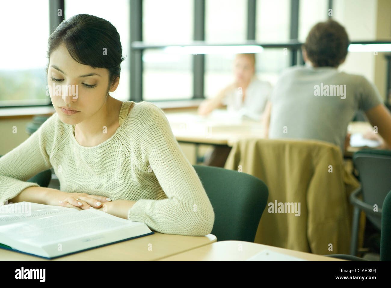 Young woman studying in university library Stock Photo - Alamy