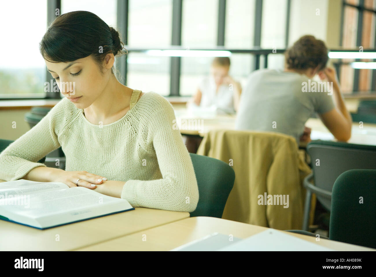 Young woman studying in university library Stock Photo - Alamy