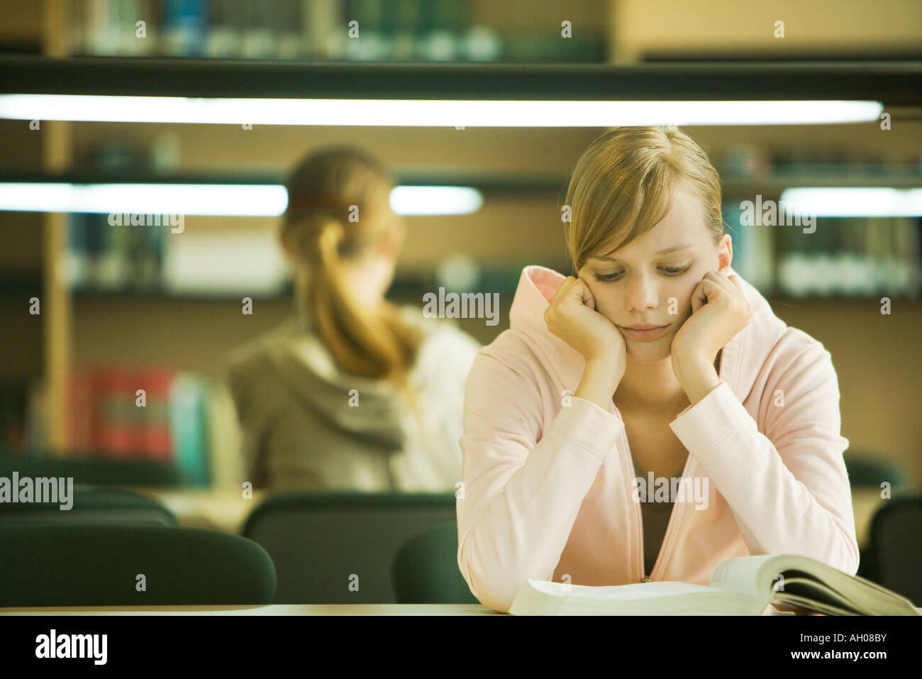 Young woman studying in university library Stock Photo - Alamy
