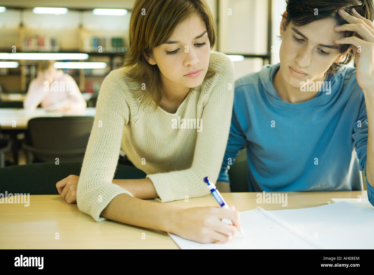 Students studying together in university library Stock Photo - Alamy