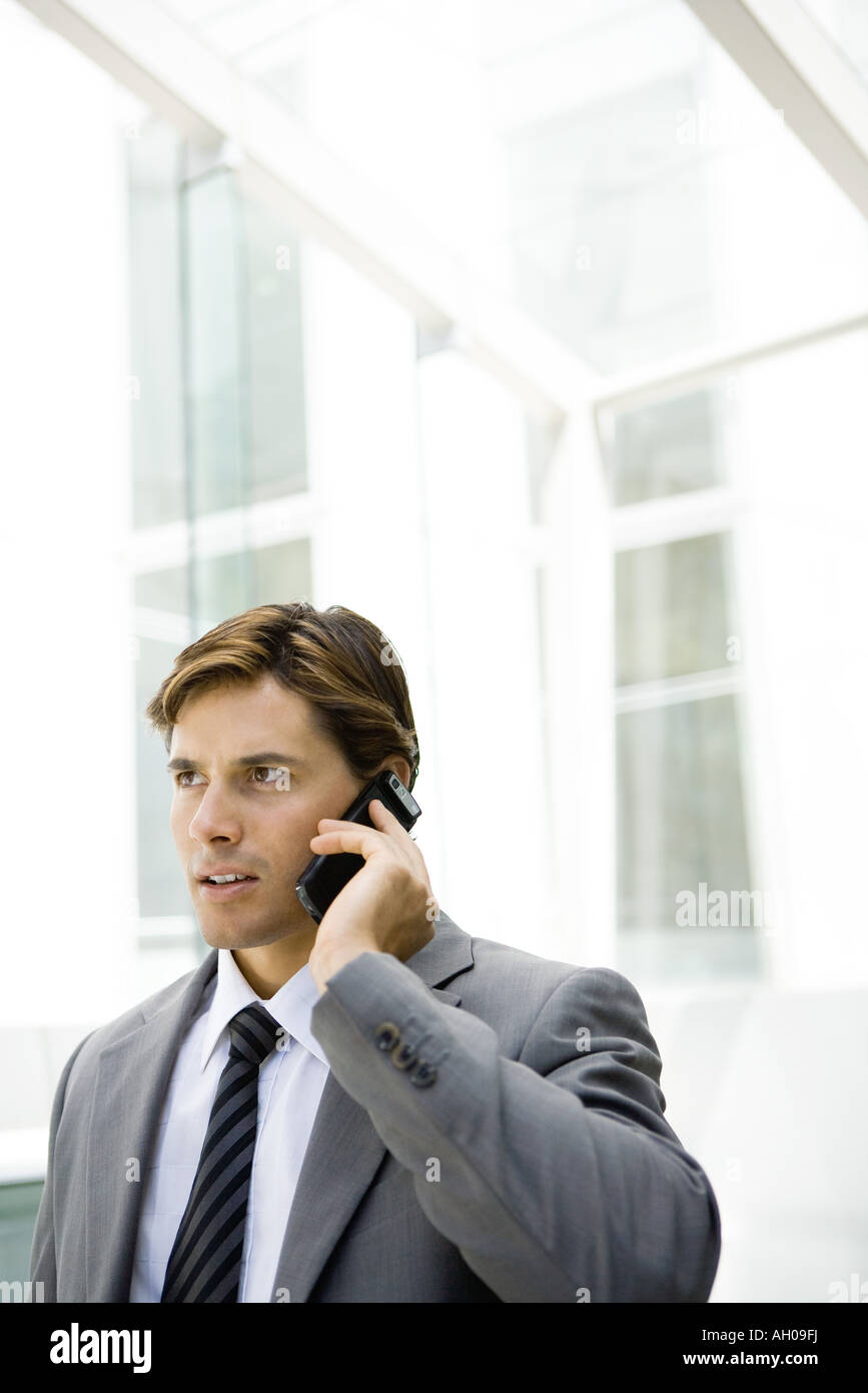 Businessman using cell phone, looking away, head and shoulders Stock ...
