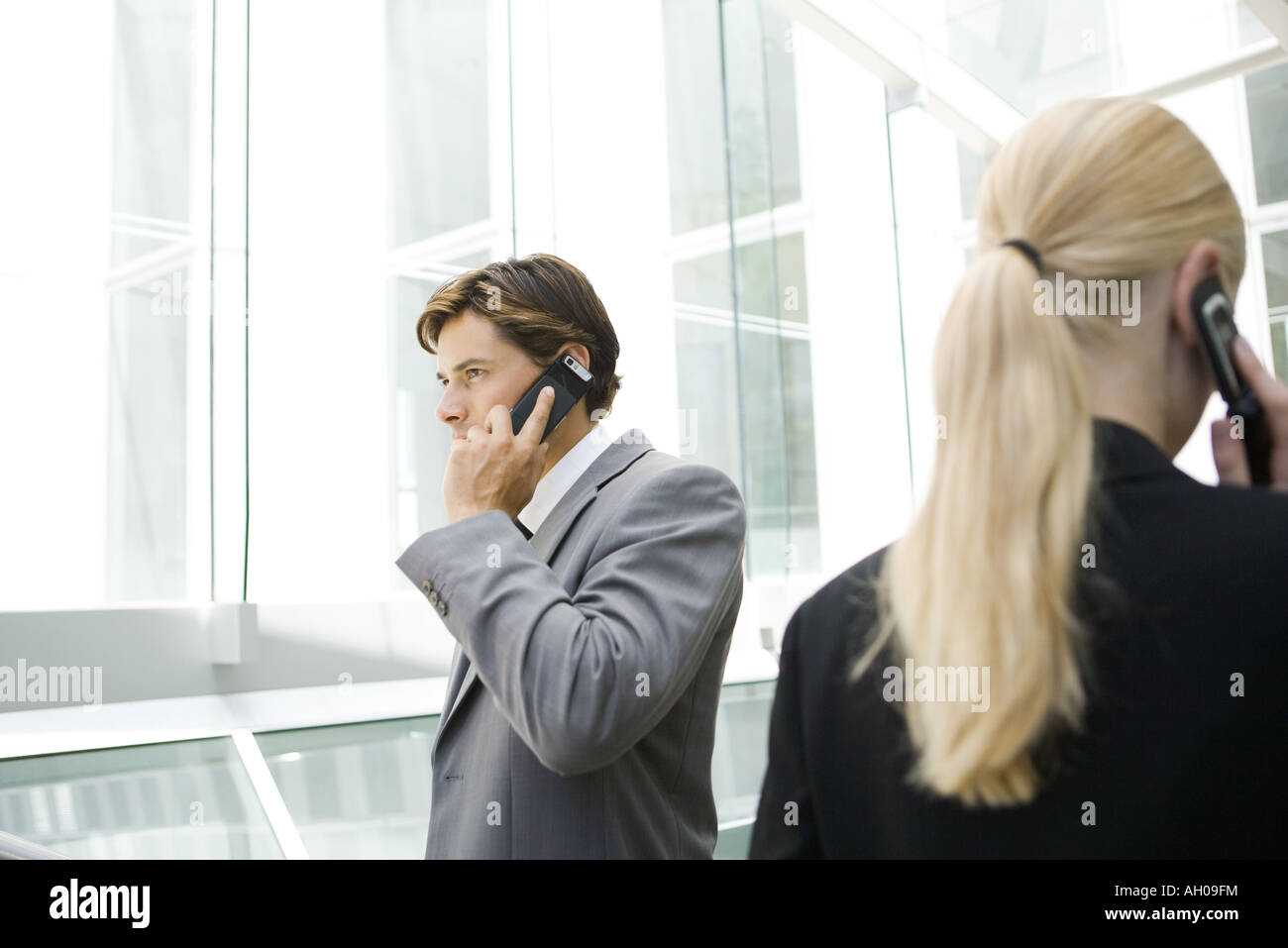 Business people walking past windows hi-res stock photography and ...