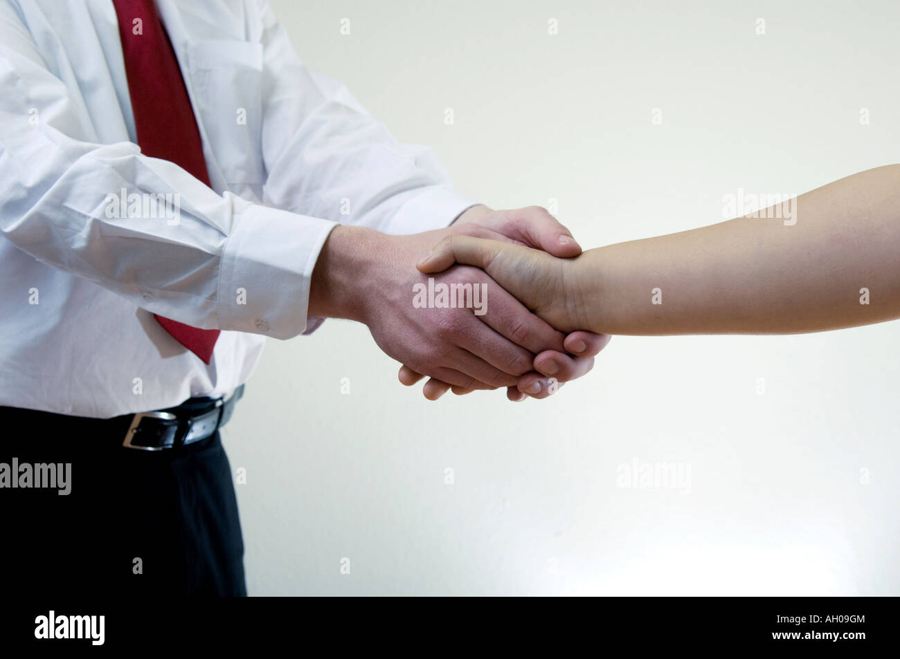 two handed hand shake by business man and woman Stock Photo - Alamy