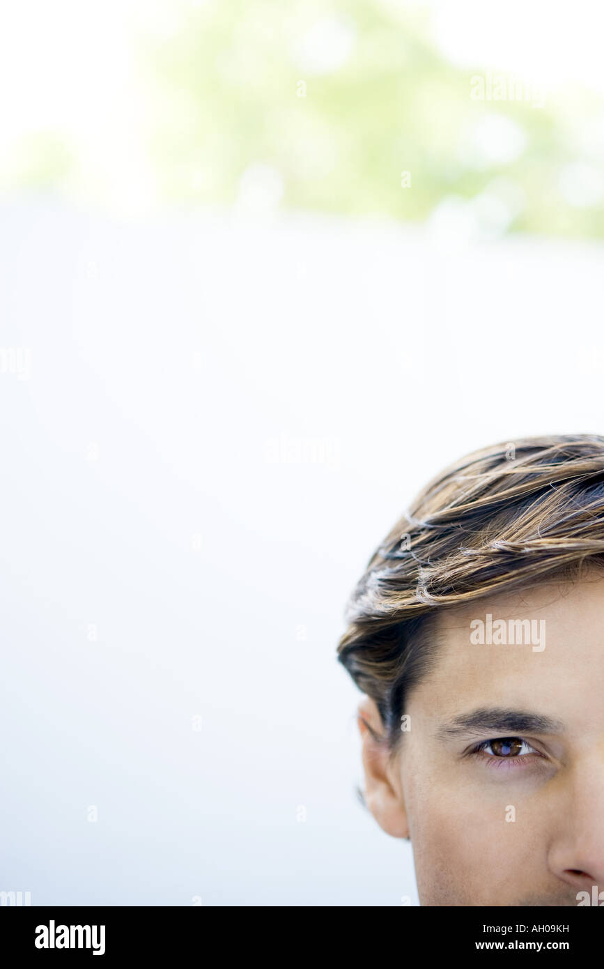 Young man looking at camera, cropped view of head Stock Photo - Alamy