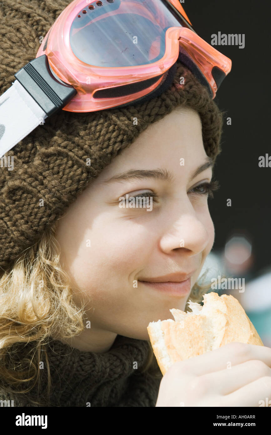 Girl wearing ski gear, eating sandwich, close-up Stock Photo - Alamy