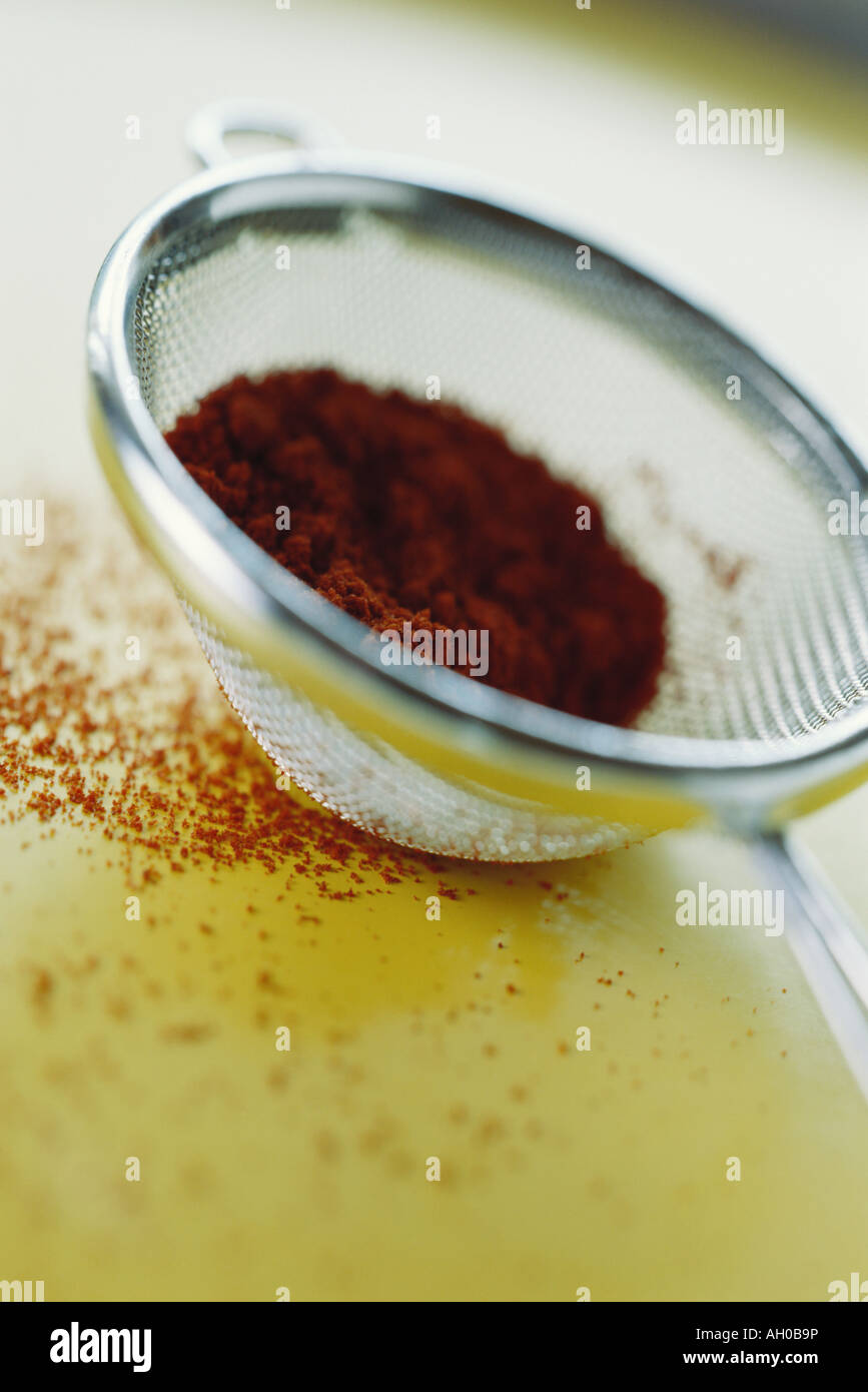 Cocoa powder in strainer hi-res stock photography and images - Alamy