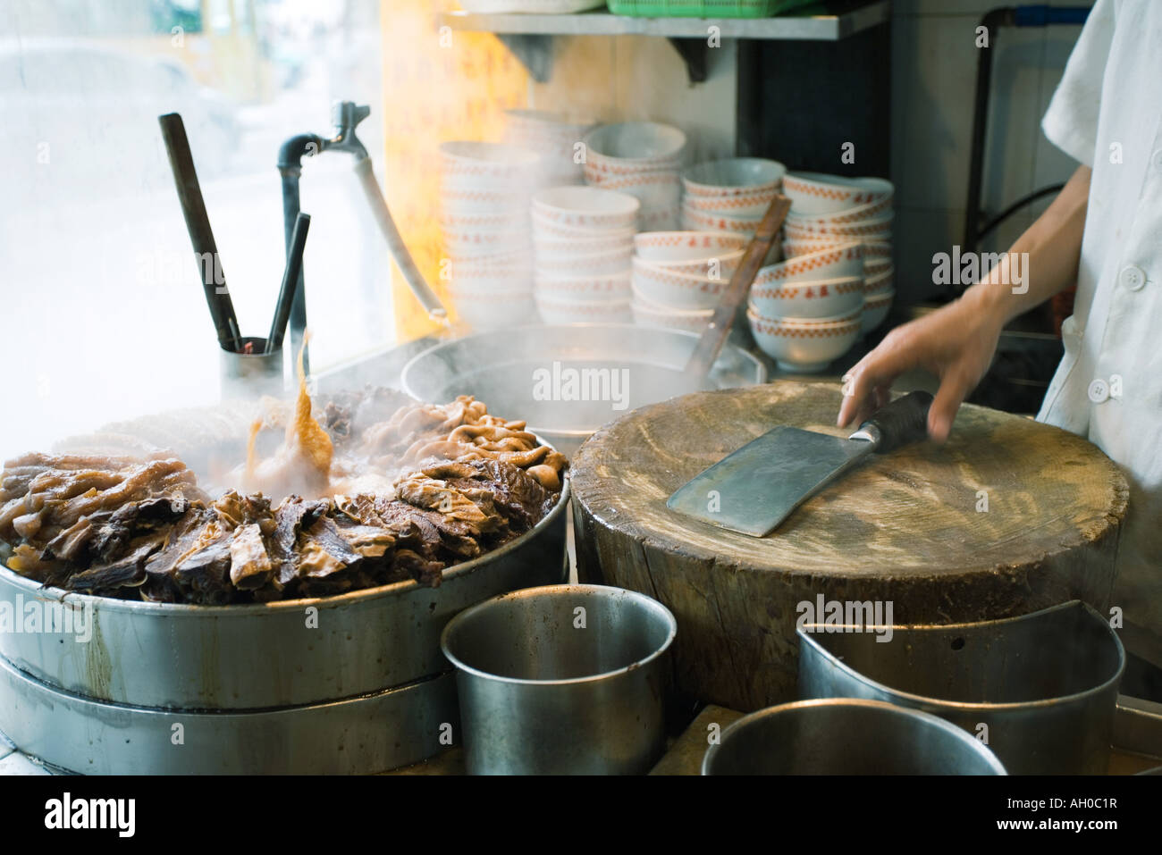 Man cooking at outside stand, China Stock Photo - Alamy