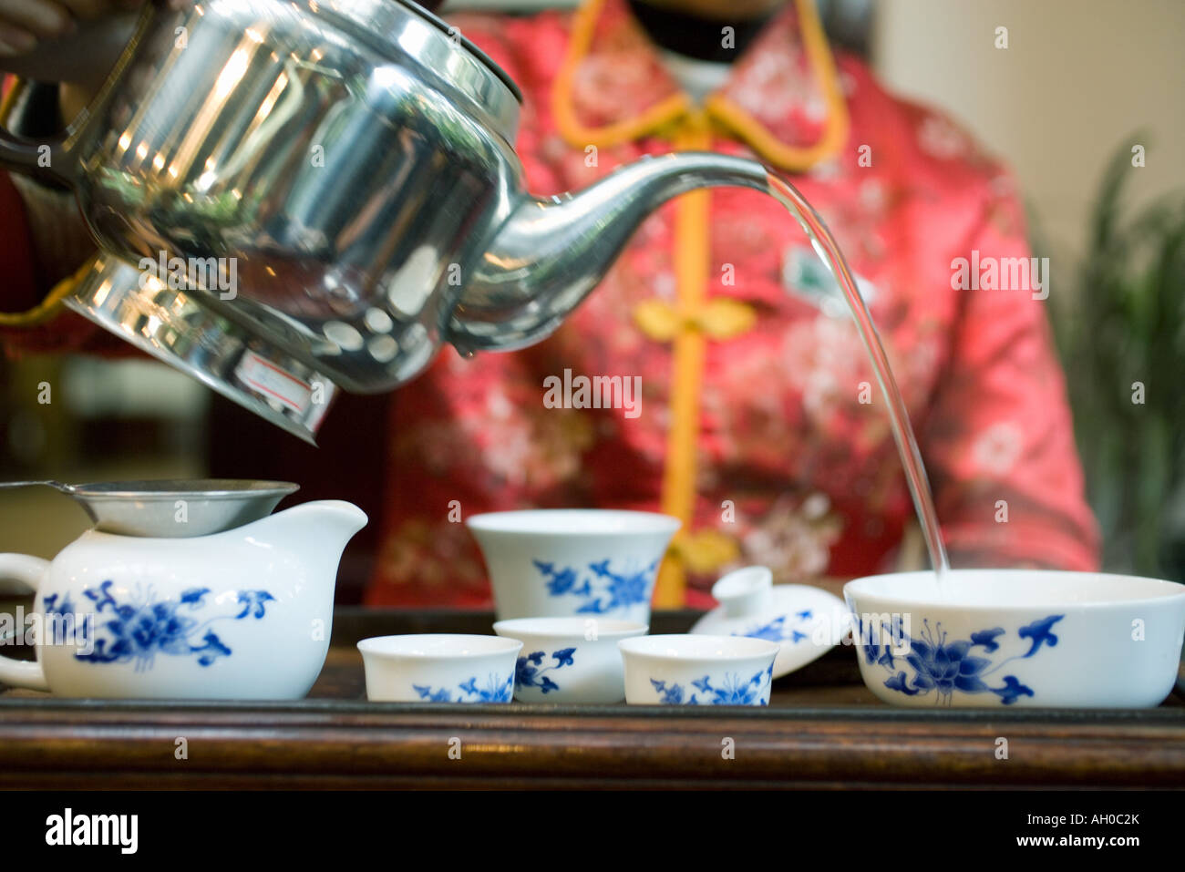 Woman serving tea, cropped view Stock Photo - Alamy
