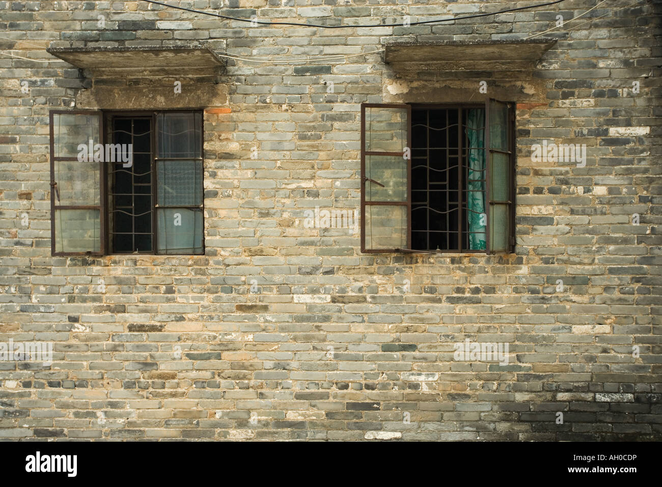 Barred windows in side of building Stock Photo - Alamy
