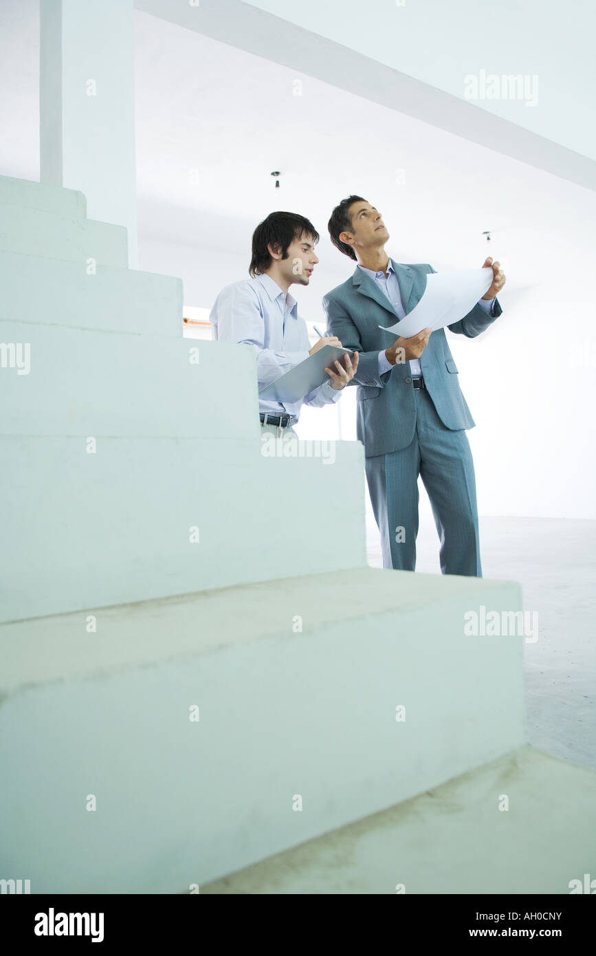 Two well-dressed men inspecting home interior Stock Photo - Alamy