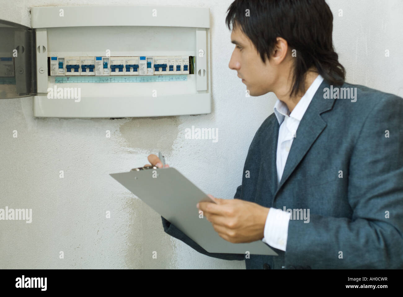Man inspecting fuse box Stock Photo - Alamy