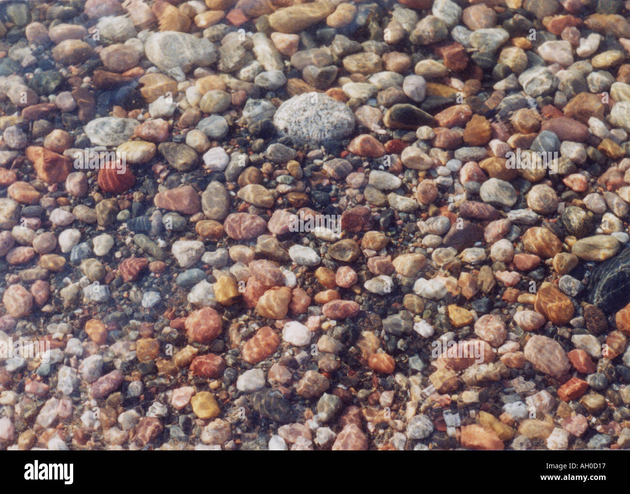 Colored pebbles and stones along the shoreline of Lake Superior in the ...