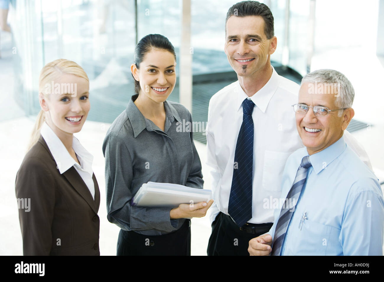Four business associates, smiling at camera, portrait Stock Photo - Alamy