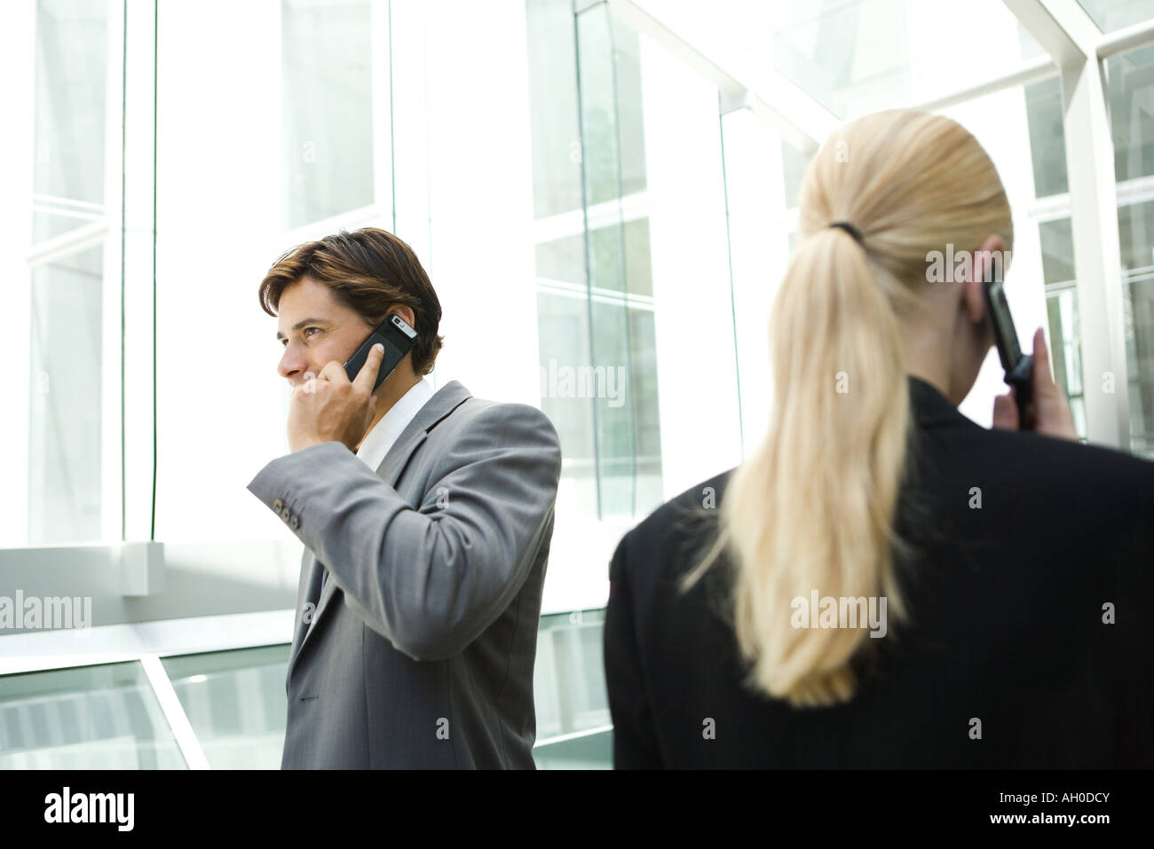 Business people walking past windows hi-res stock photography and ...