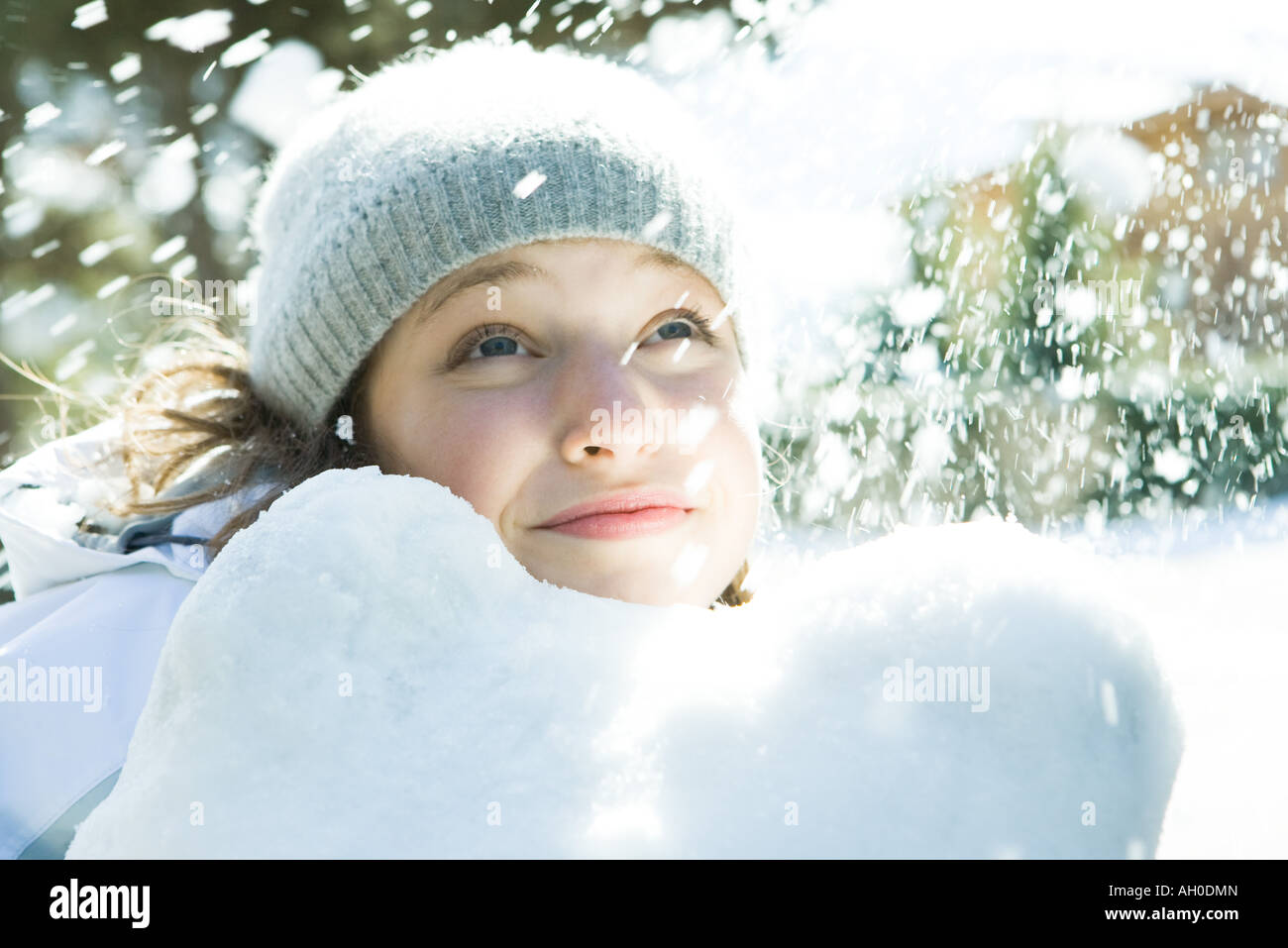 Teenage girl looking up at snow, smiling, portrait Stock Photo - Alamy