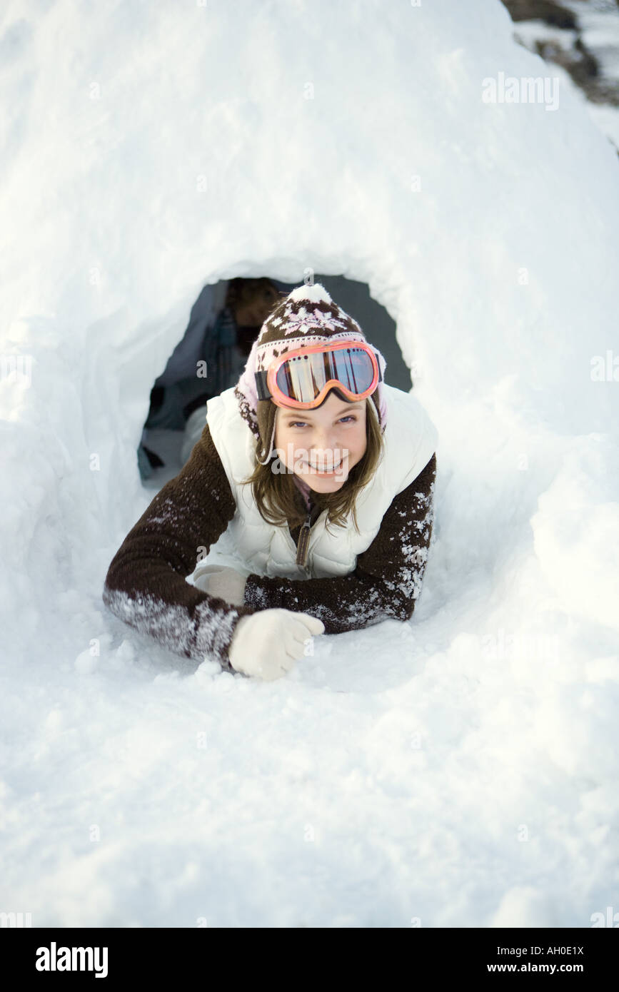 Teen girl crawling out of tunnel in snow Stock Photo - Alamy