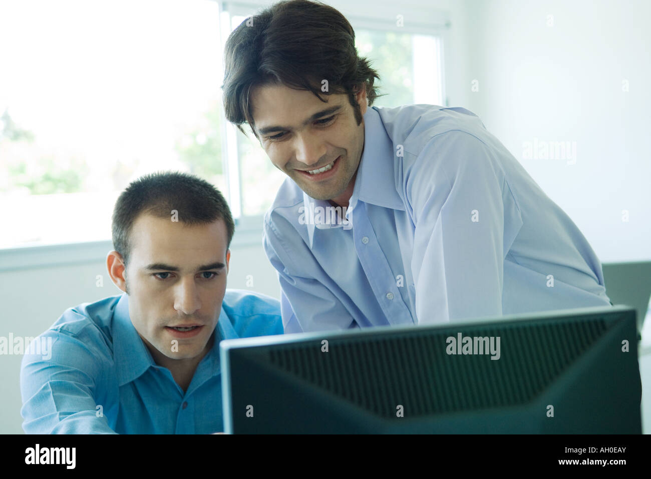 Two businessmen looking at computer, head and shoulders Stock Photo - Alamy