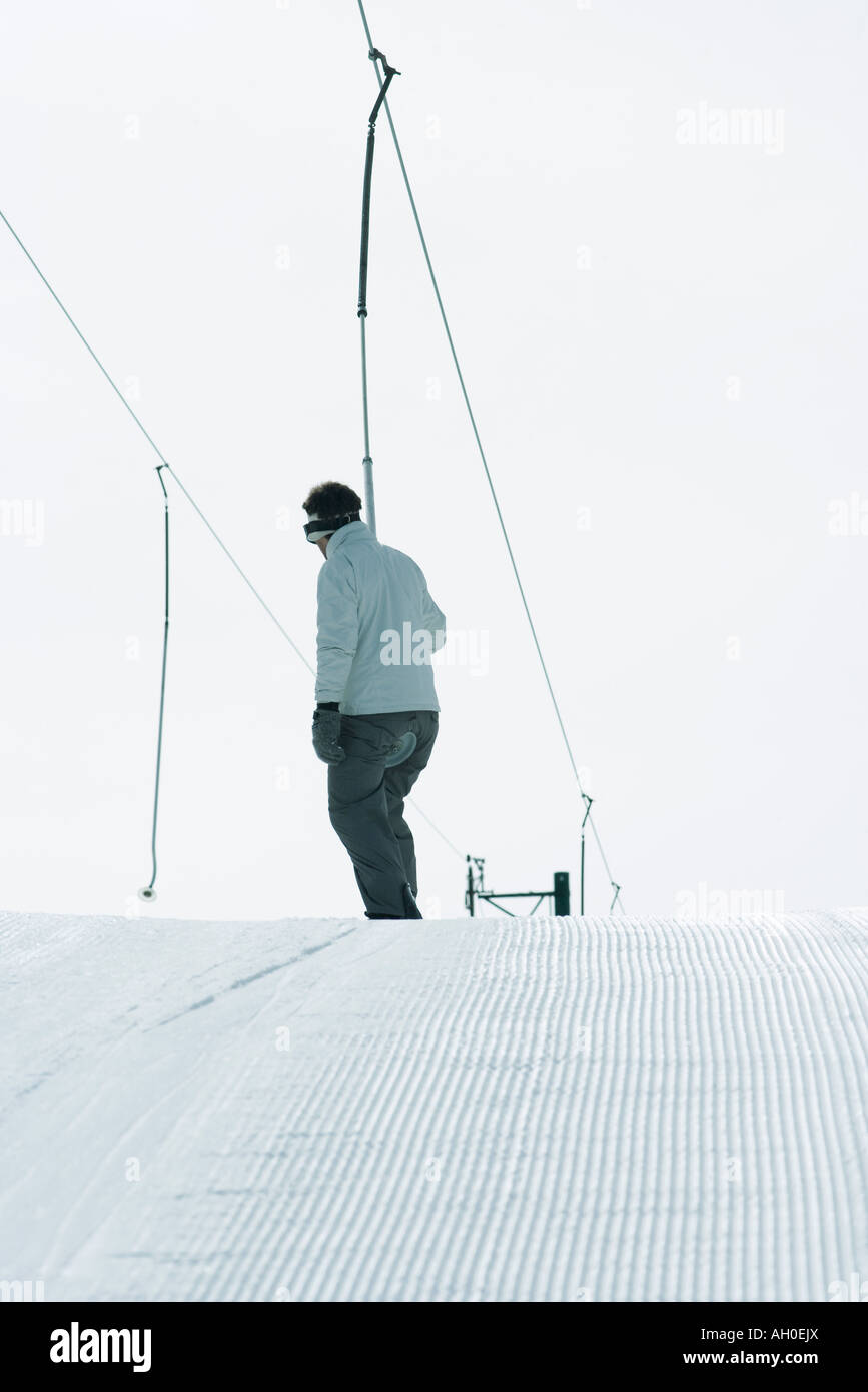 Young skier riding ski lift, rear view Stock Photo - Alamy